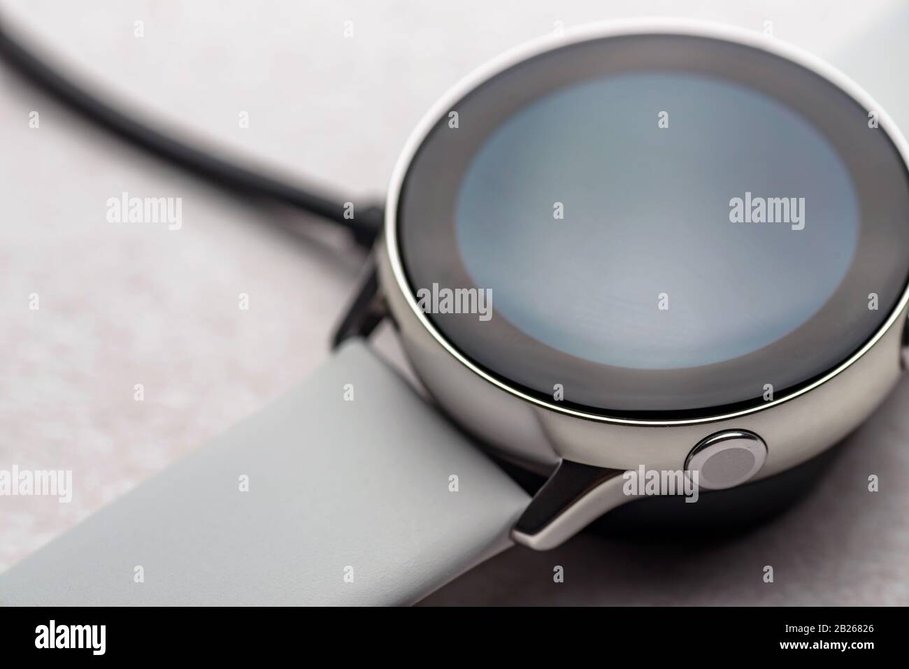 smart watch wireless charging on charging pad on kitchen worktop table ...