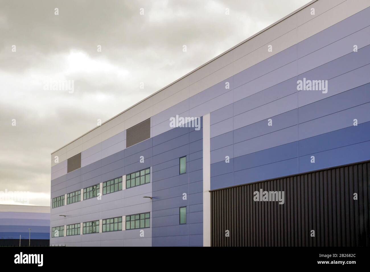 modern warehouse building over cloudy sky in england uk Stock Photo - Alamy
