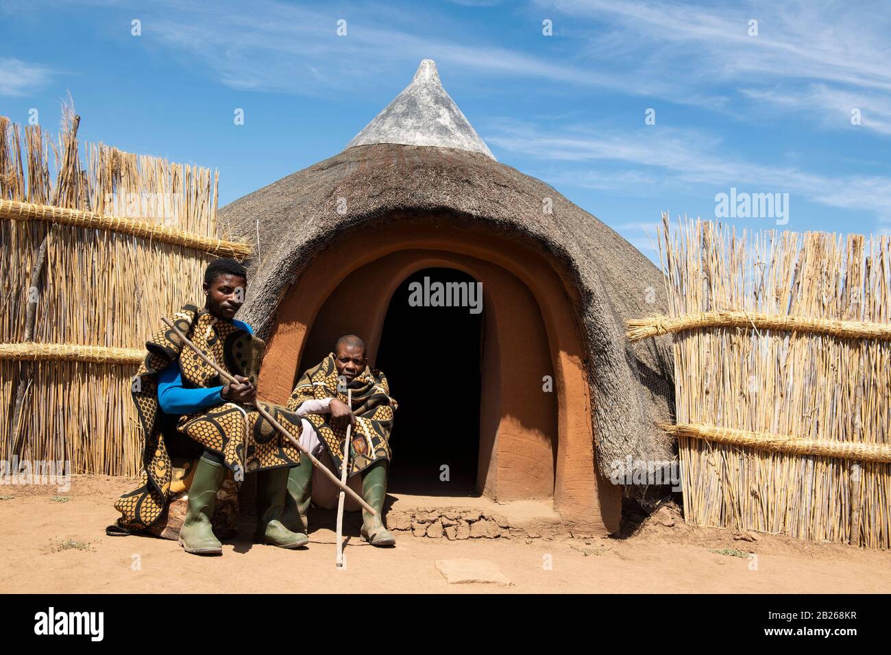 Basotho men in front of traditional hut, Thaba Bosiu Cultural Village ...