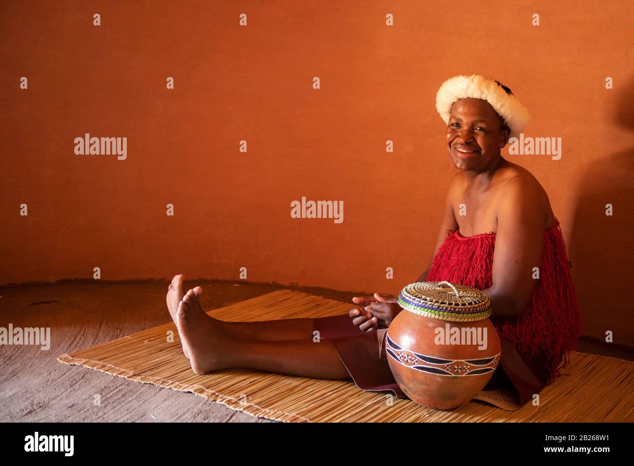 Basotho woman in a traditional hut, Thaba Bosiu Cultural Village ...