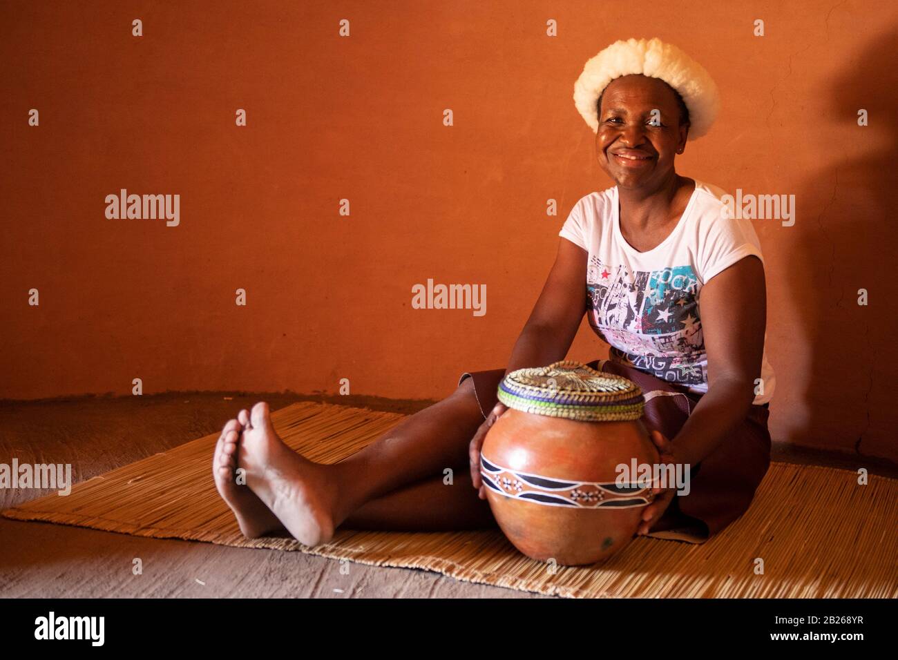 Basotho woman in a traditional hut, Thaba Bosiu Cultural Village ...