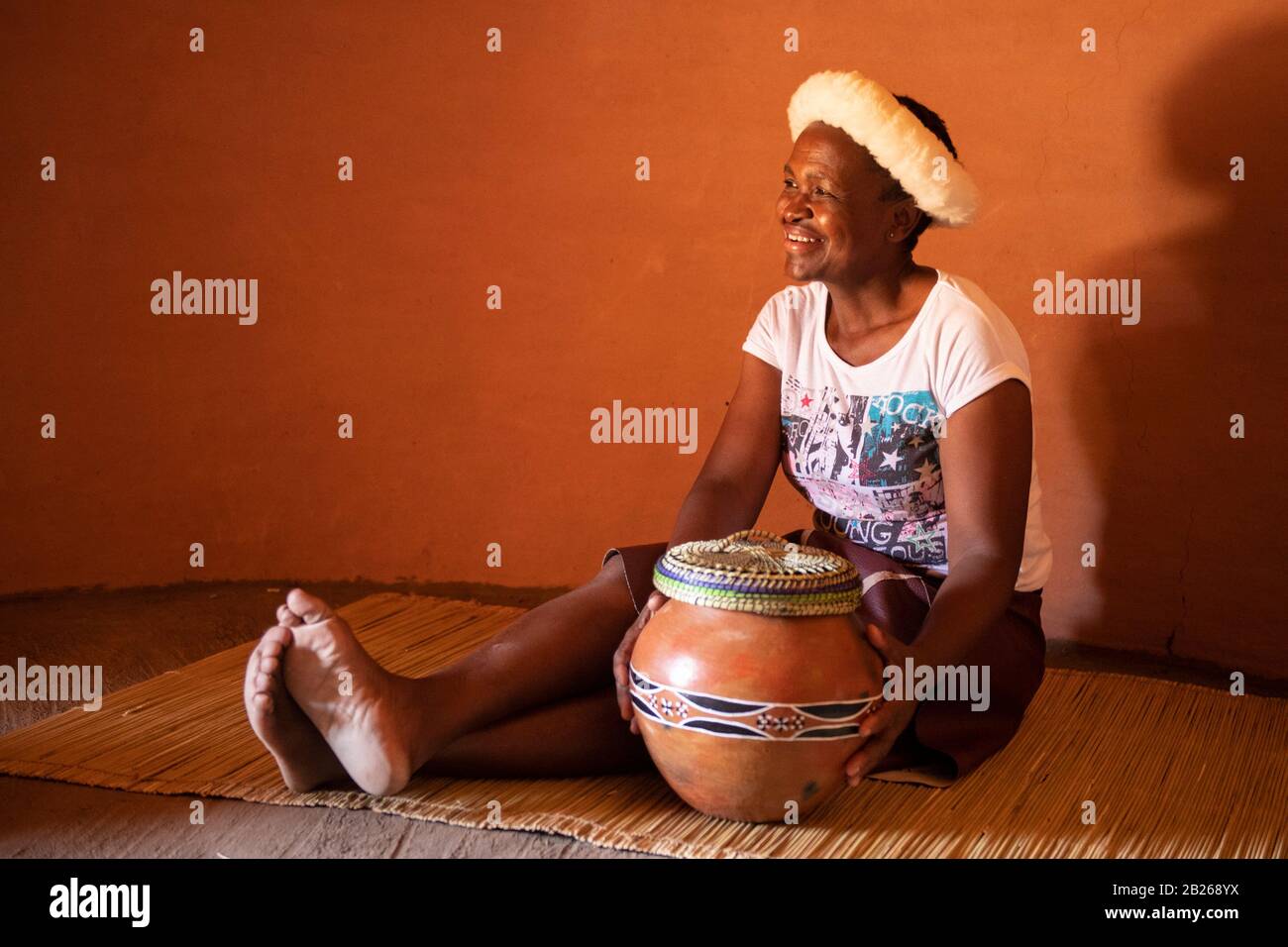 Basotho woman in a traditional hut, Thaba Bosiu Cultural Village ...