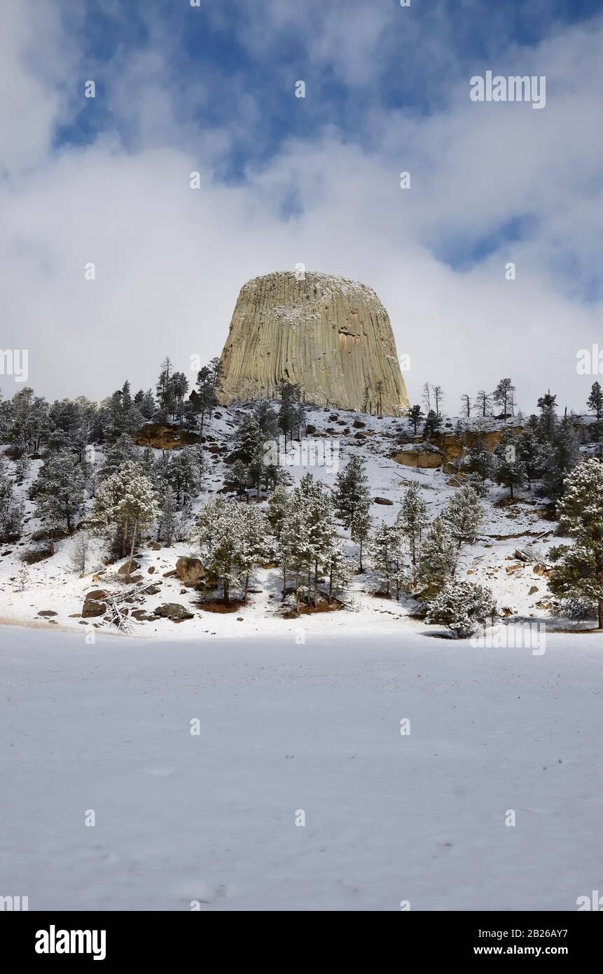 Devils Tower National Monument, Blue sky with white clouds, snowy ...
