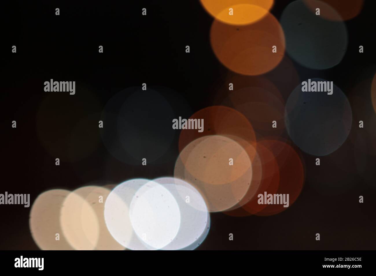Light spots round multi-colored in the night on a dark background glow ...