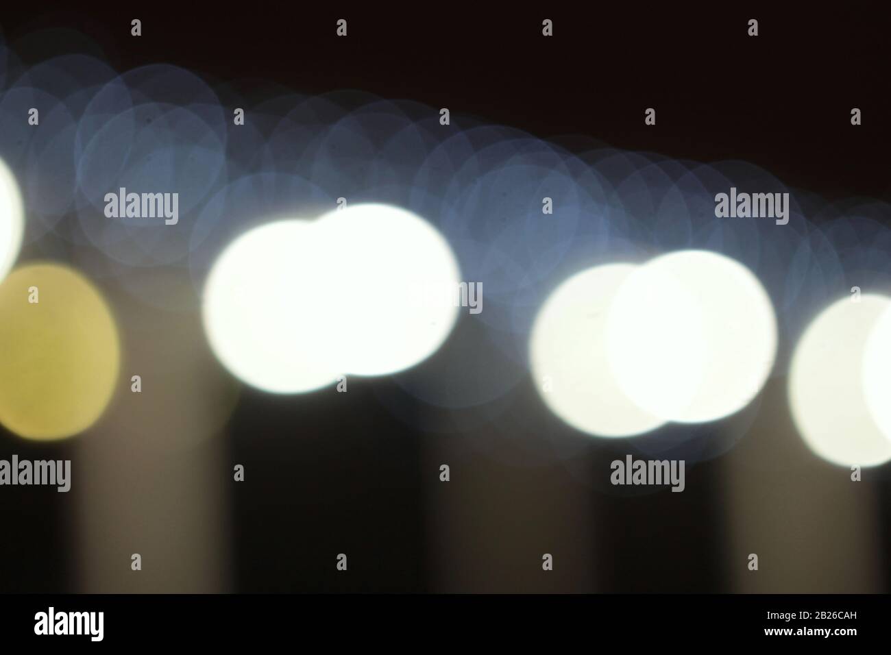 Light spots round multi-colored in the night on a dark background glow ...