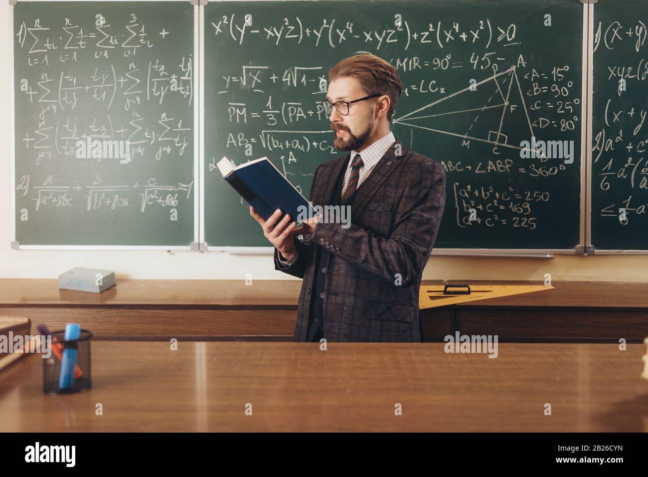 Smart enthusiastic lecturer quoting a scientific book while giving ...