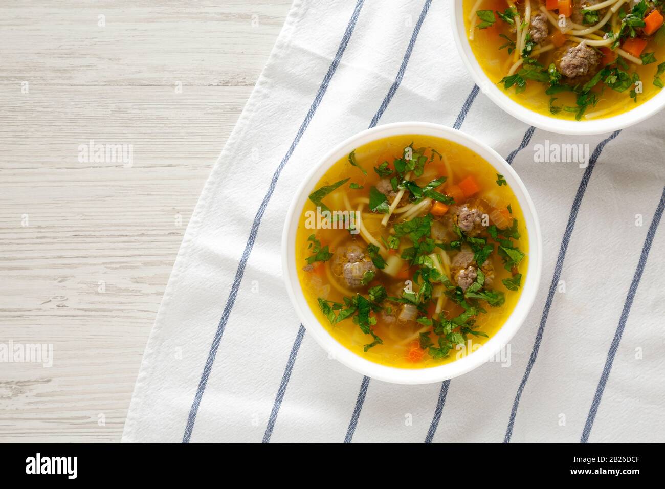 Homemade Sopa a La Minuta in white bowls on a white wooden background ...