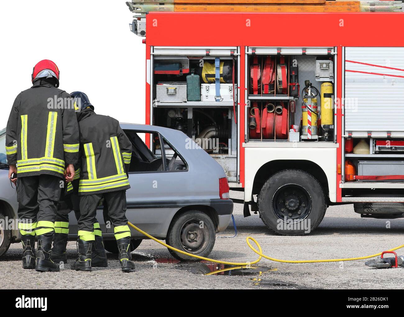 firefighters while they cut the sheet of the car with a big shears ...