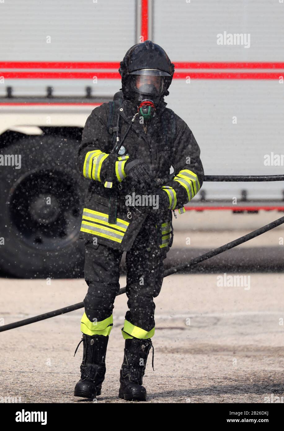 fireman with helmet and respirator with oxygen cylinders during an ...