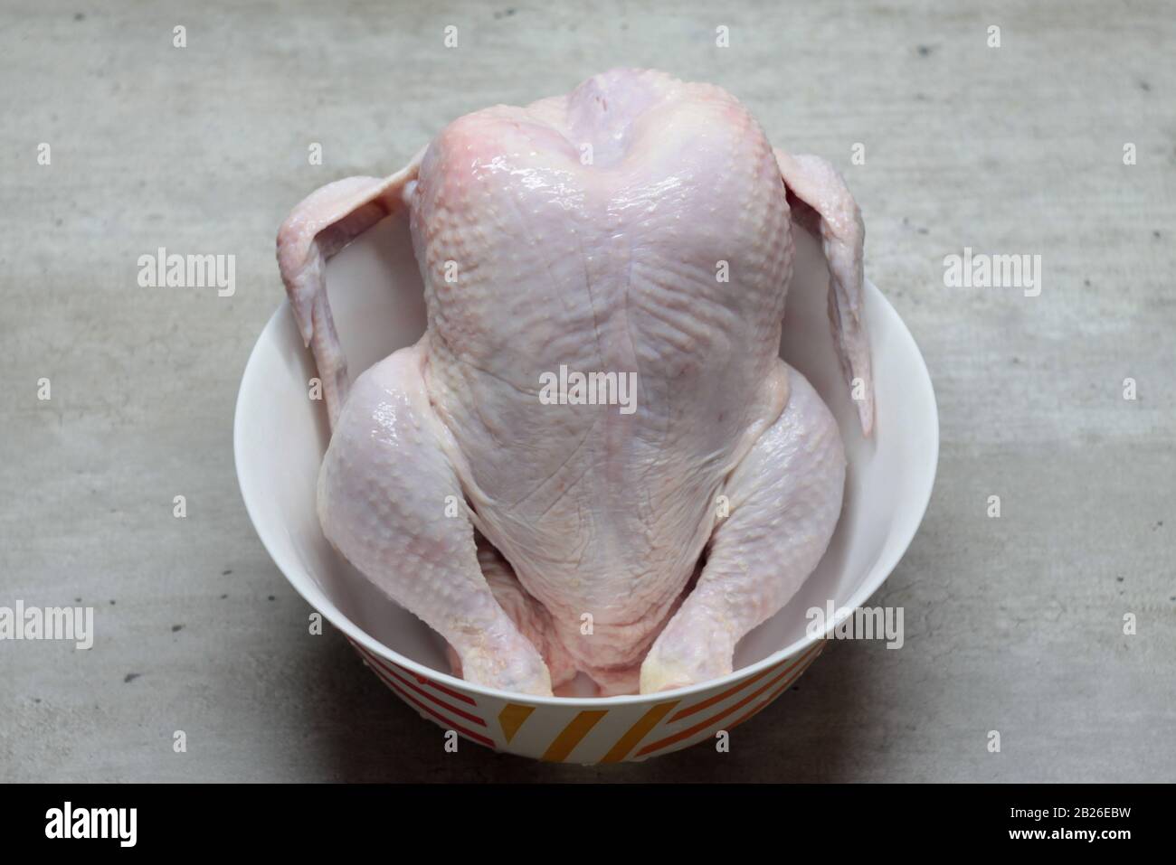 The carcass of a raw chicken lies or sits in a plate Stock Photo - Alamy