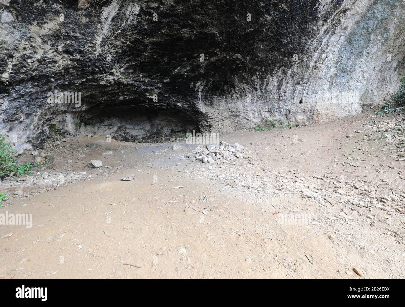 large cavern in the rock used by primitive men as a shelter during ...