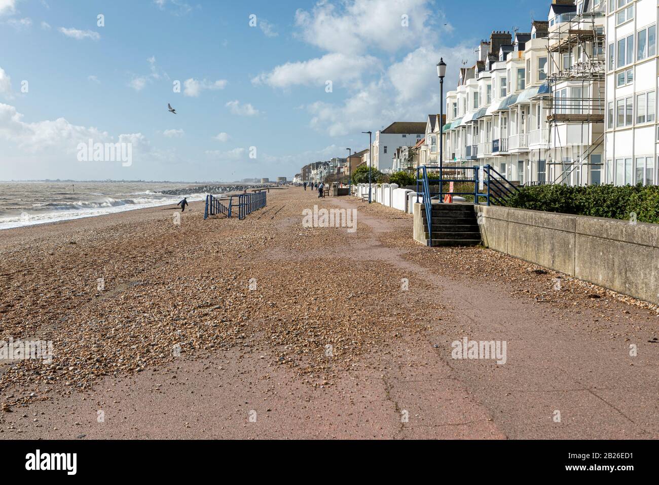 Sea defense shingle washed up on Hythe promenade Stock Photo - Alamy