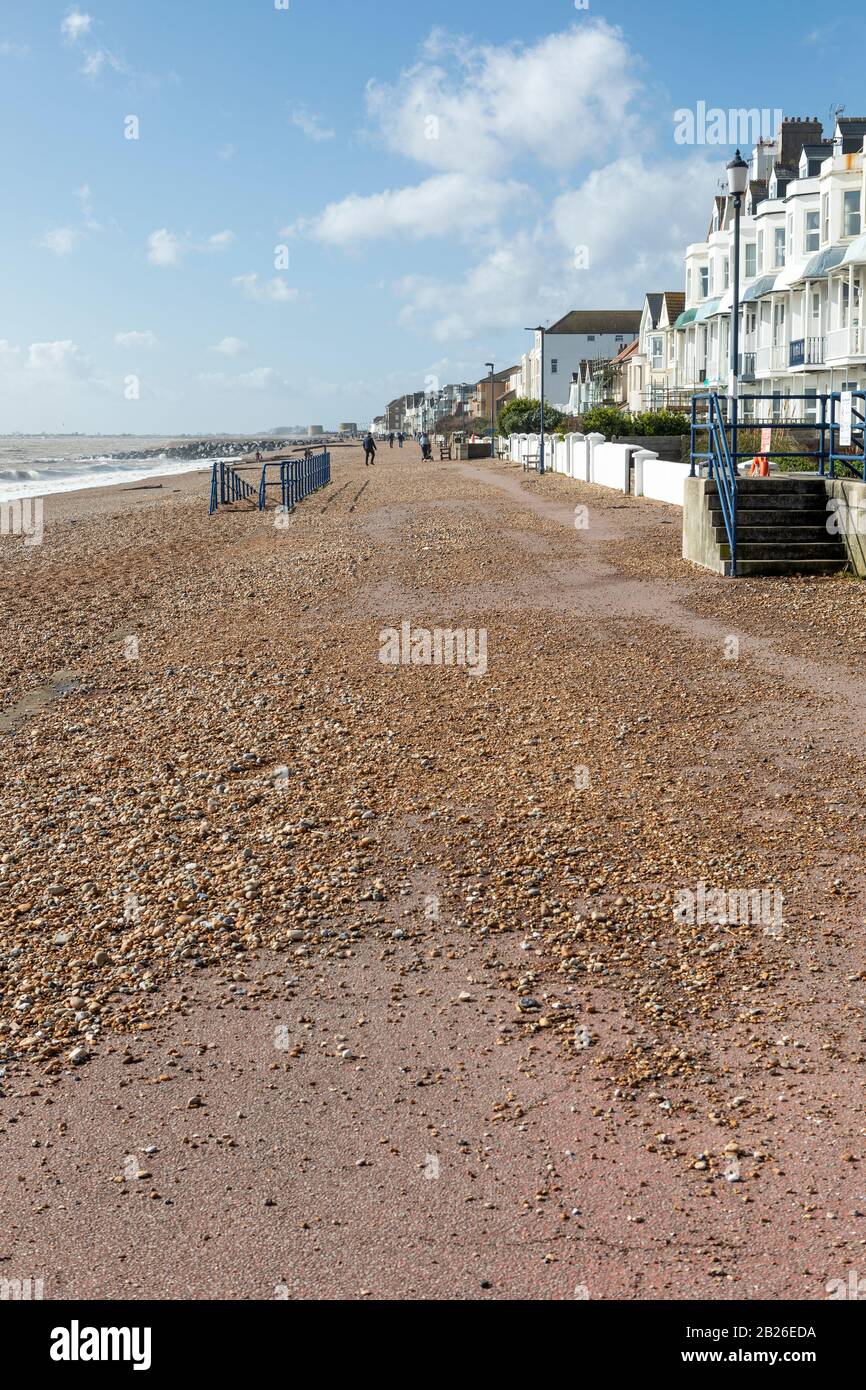 Sea defense shingle washed up on Hythe promenade Stock Photo - Alamy