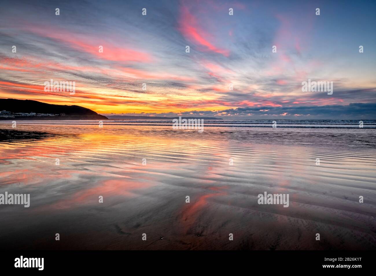 Romantic sunset, coastline, reflections in wet sand, North Devon ...