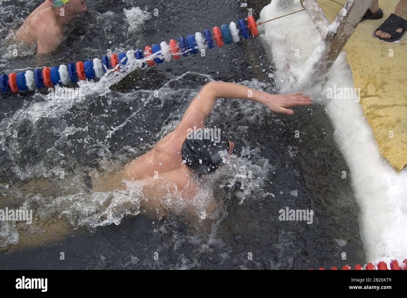 Men swim in 25 meters ice-hole Stock Photo - Alamy