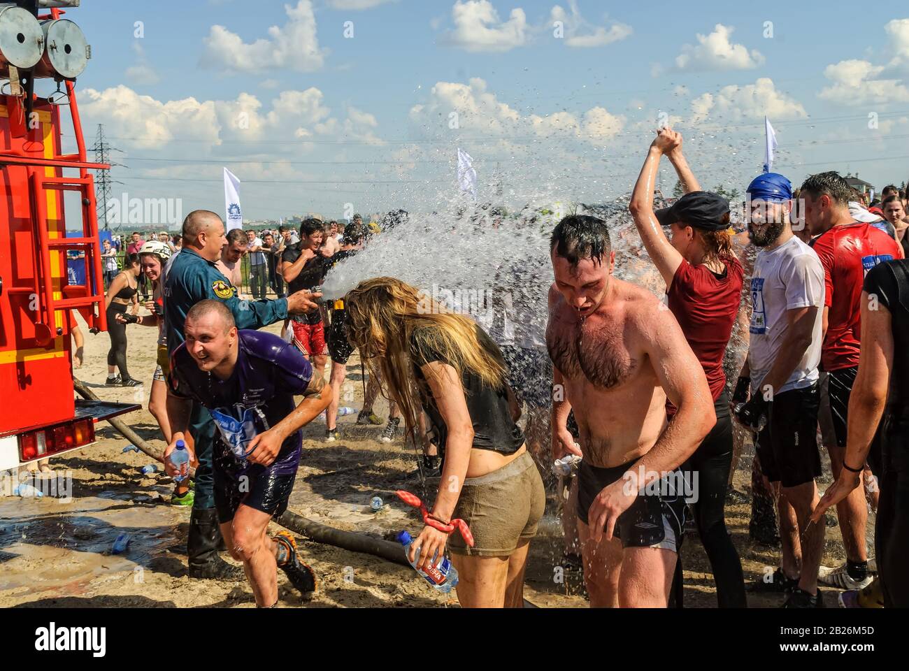 Firefighter pours water athletes after finishing Stock Photo - Alamy