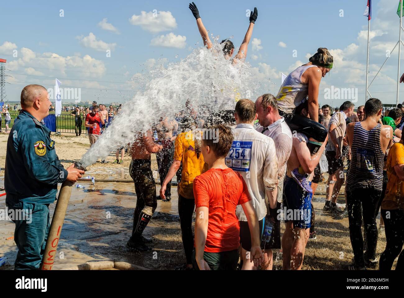 Firefighter pours water athletes after finishing Stock Photo - Alamy