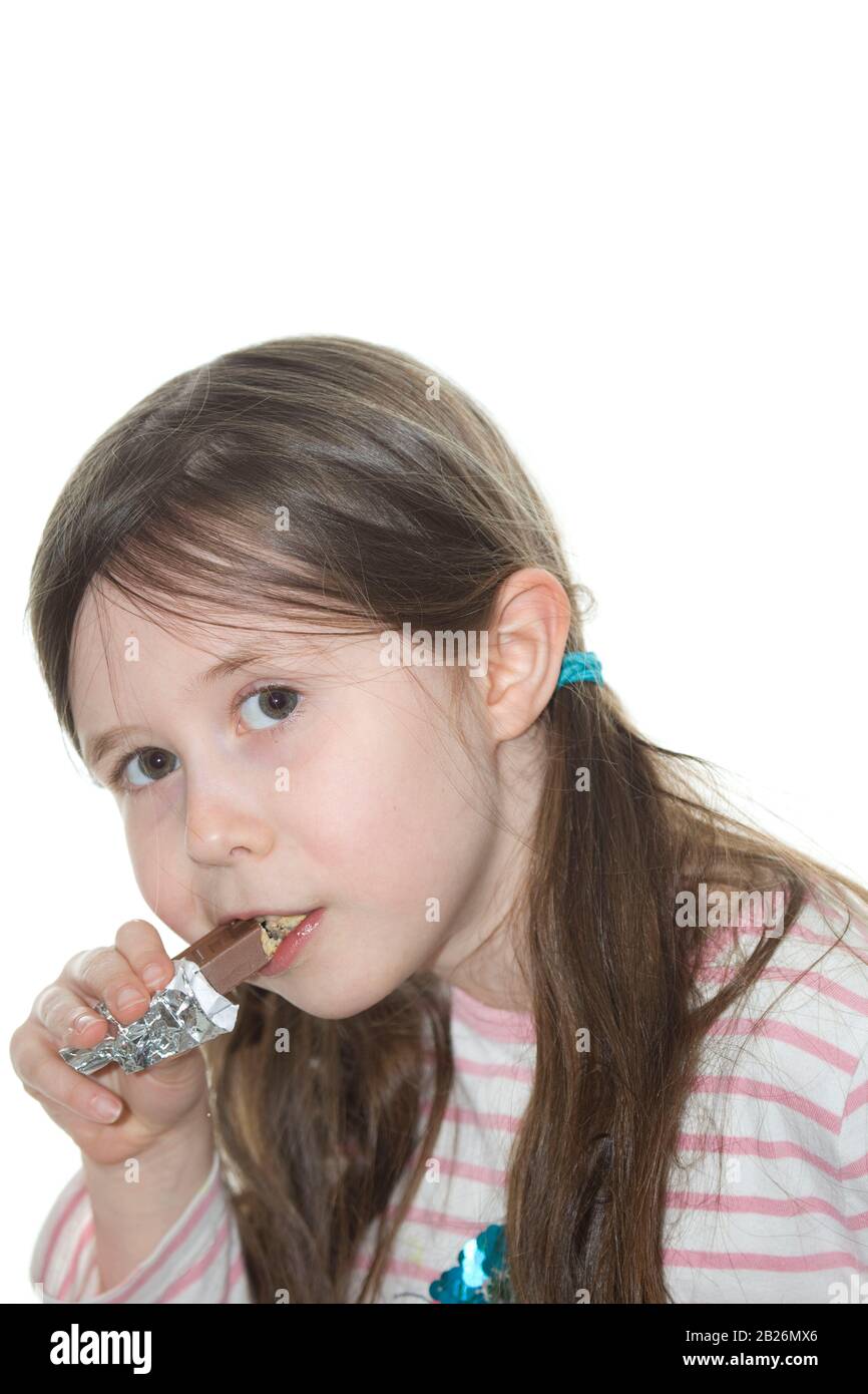 young girl eating a chocolate biscuit on white background Stock Photo ...