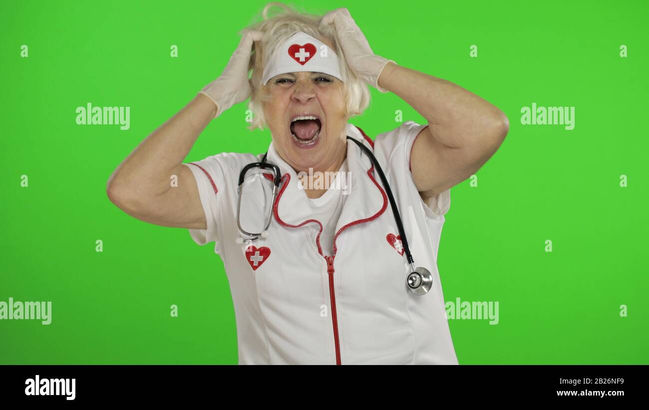 Portrait of elderly caucasian female doctor. Crazy and funny nurse ...