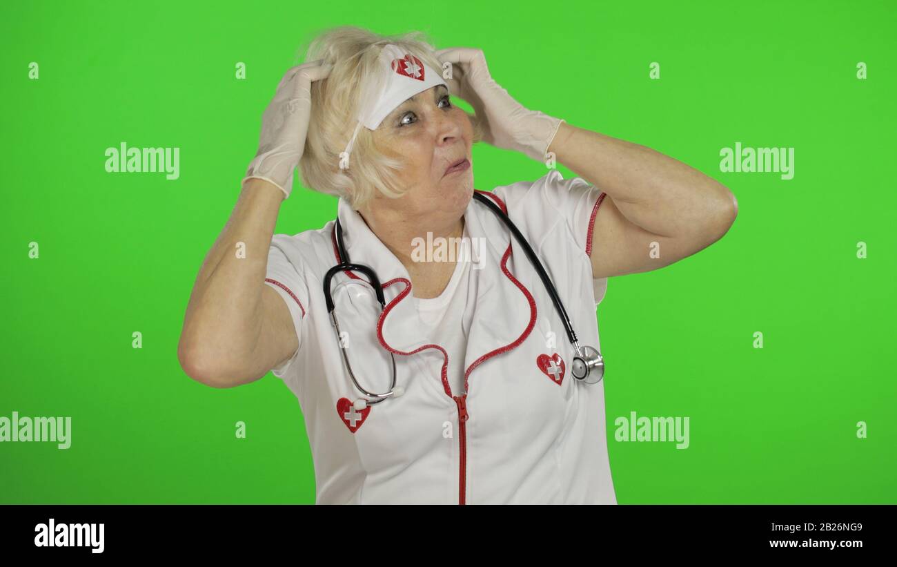 Portrait of elderly caucasian female doctor. Crazy and funny nurse ...
