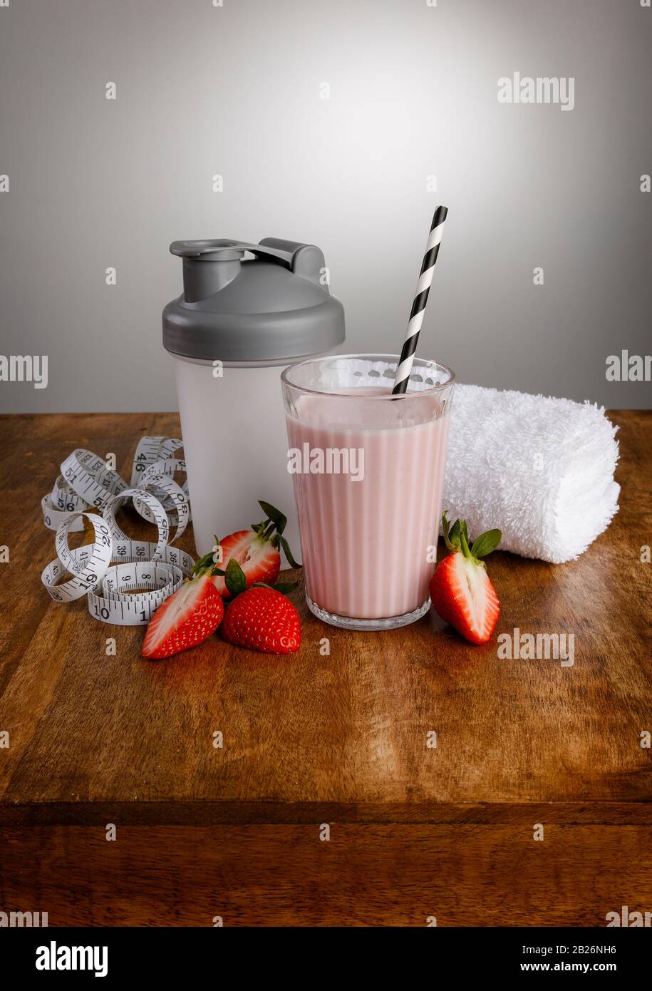 Strawberry orange milkshake, ingredients, tape measure, towel and ...