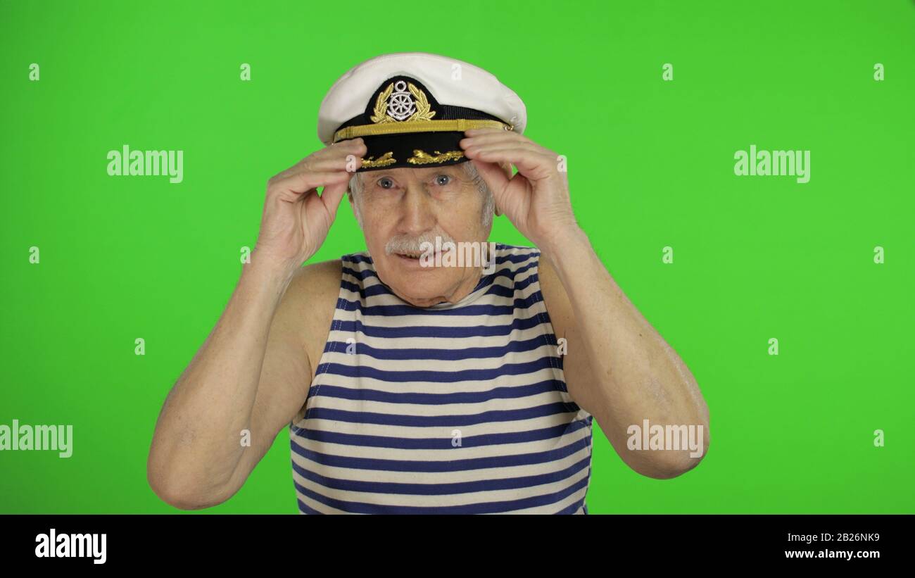 Elderly sailor man. Old man with mustache in hat and striped shirt on ...