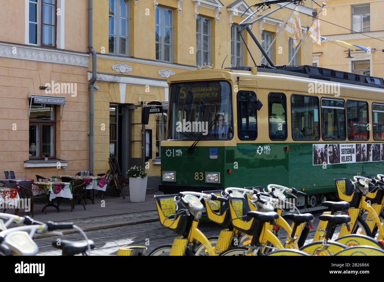 Public transport of Helsinki, Finland: yellow bicycles for rent against ...