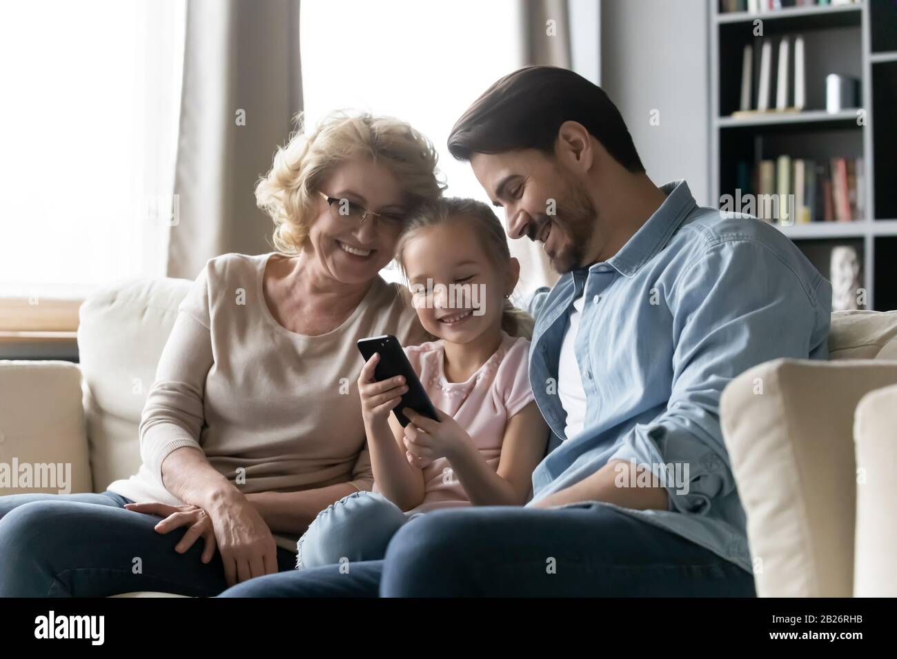Happy three family generations using modern smartphone Stock Photo - Alamy