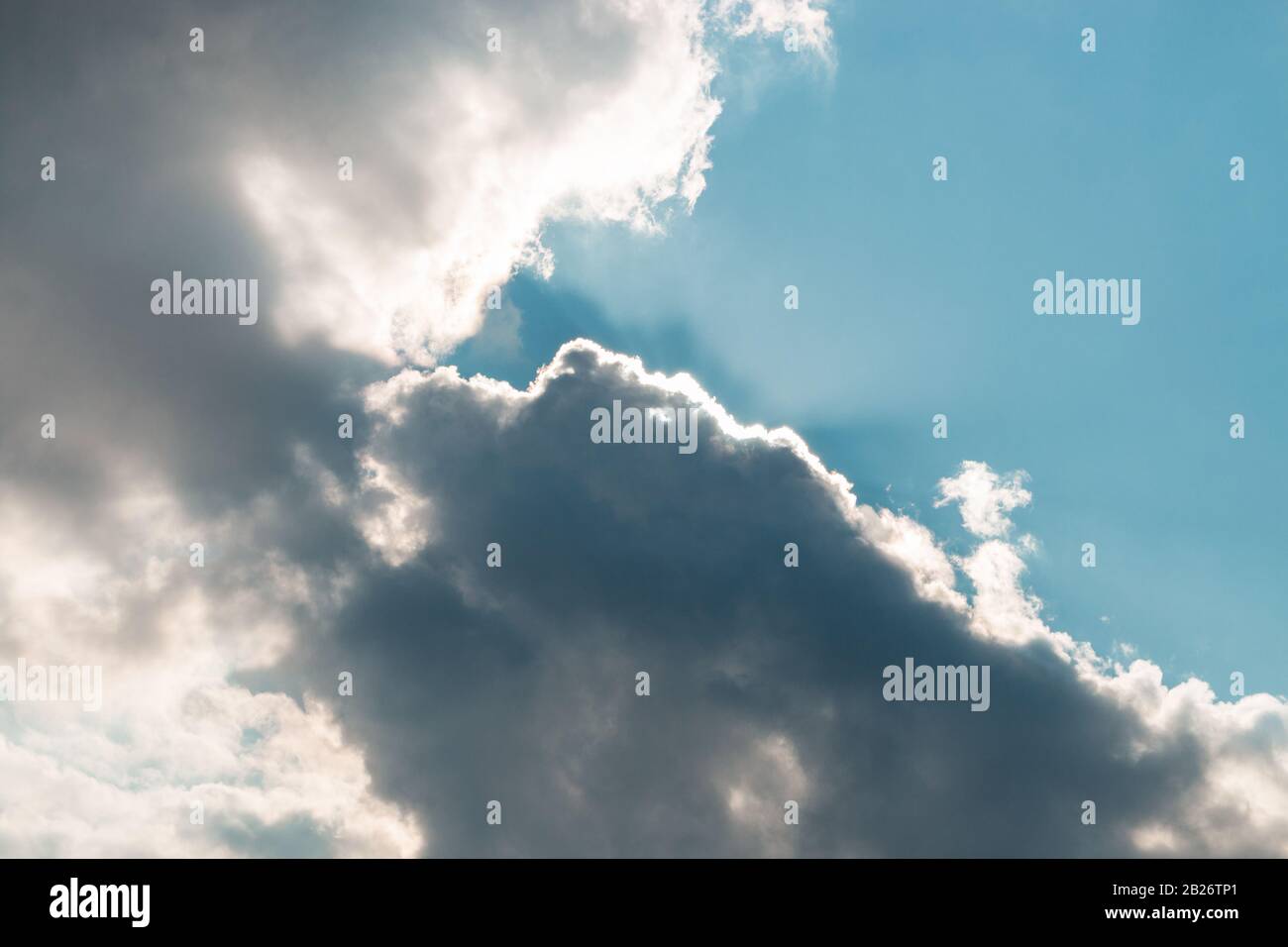 spring sky. clouds covering the sun and beams peering under them Stock ...