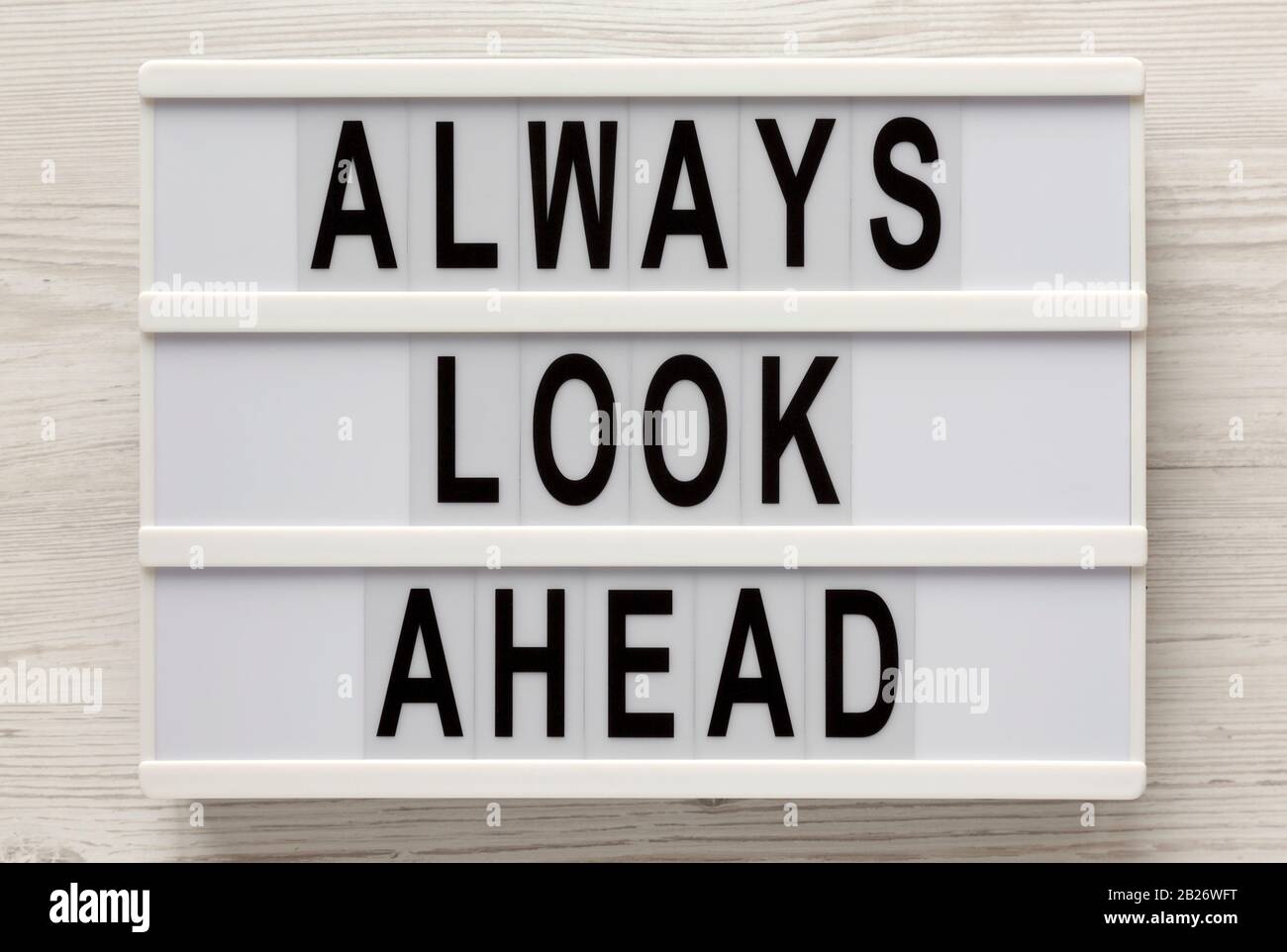 'Always look ahead' words on a modern board, clipboard with blank sheet ...
