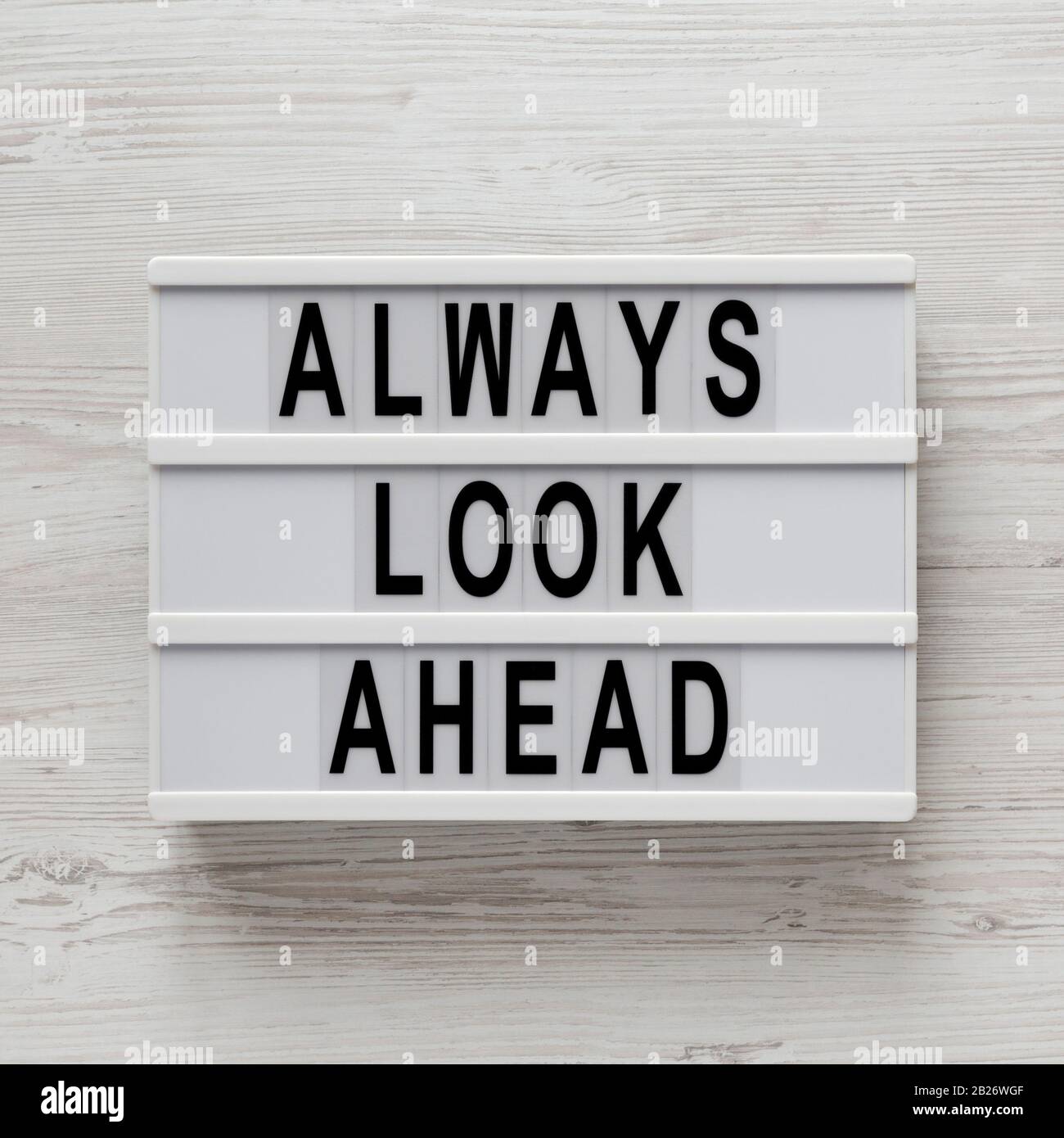 'Always look ahead' words on a modern board, clipboard with blank sheet ...