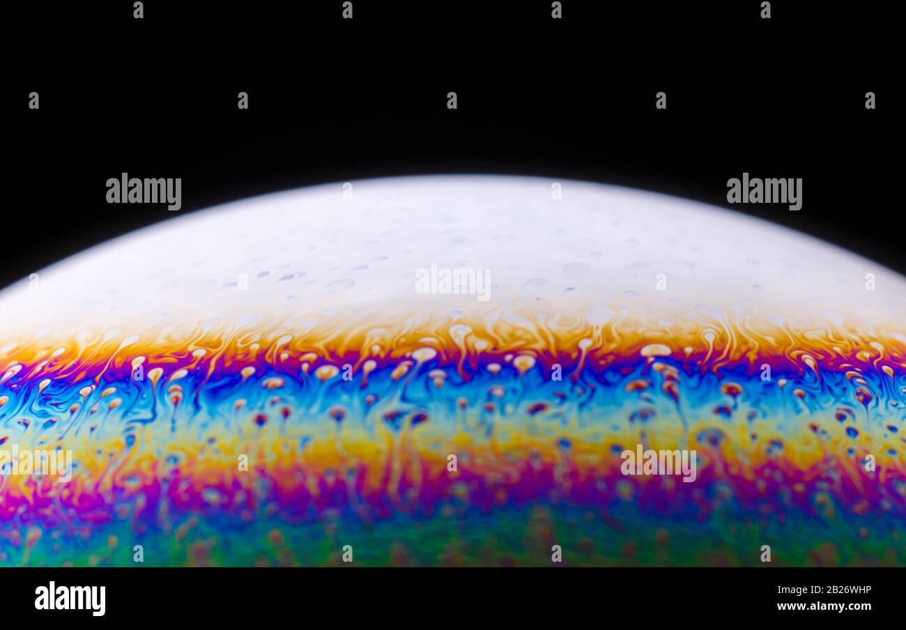 Macro of colorful iridescent soap bubble with abstract patterns and ...