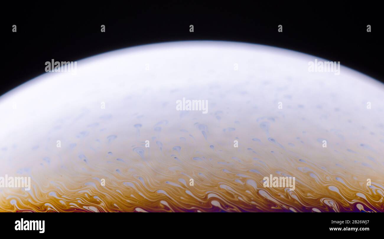 Macro of colorful iridescent soap bubble with abstract patterns and ...