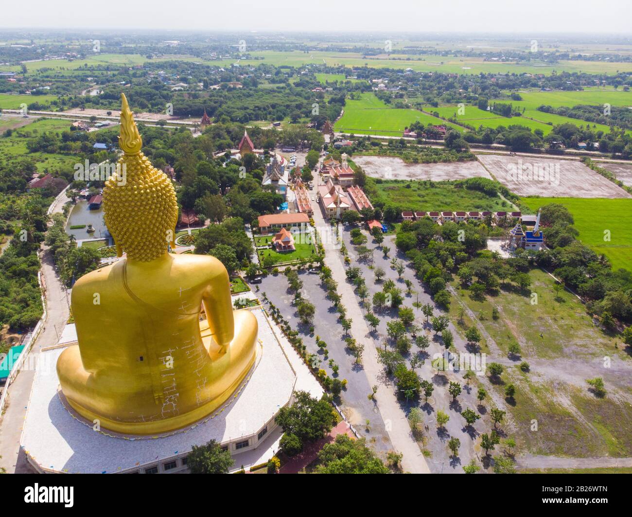 Golden buddha statue in buddhism temple with rice plantation aerial view Stock Photo - Alamy