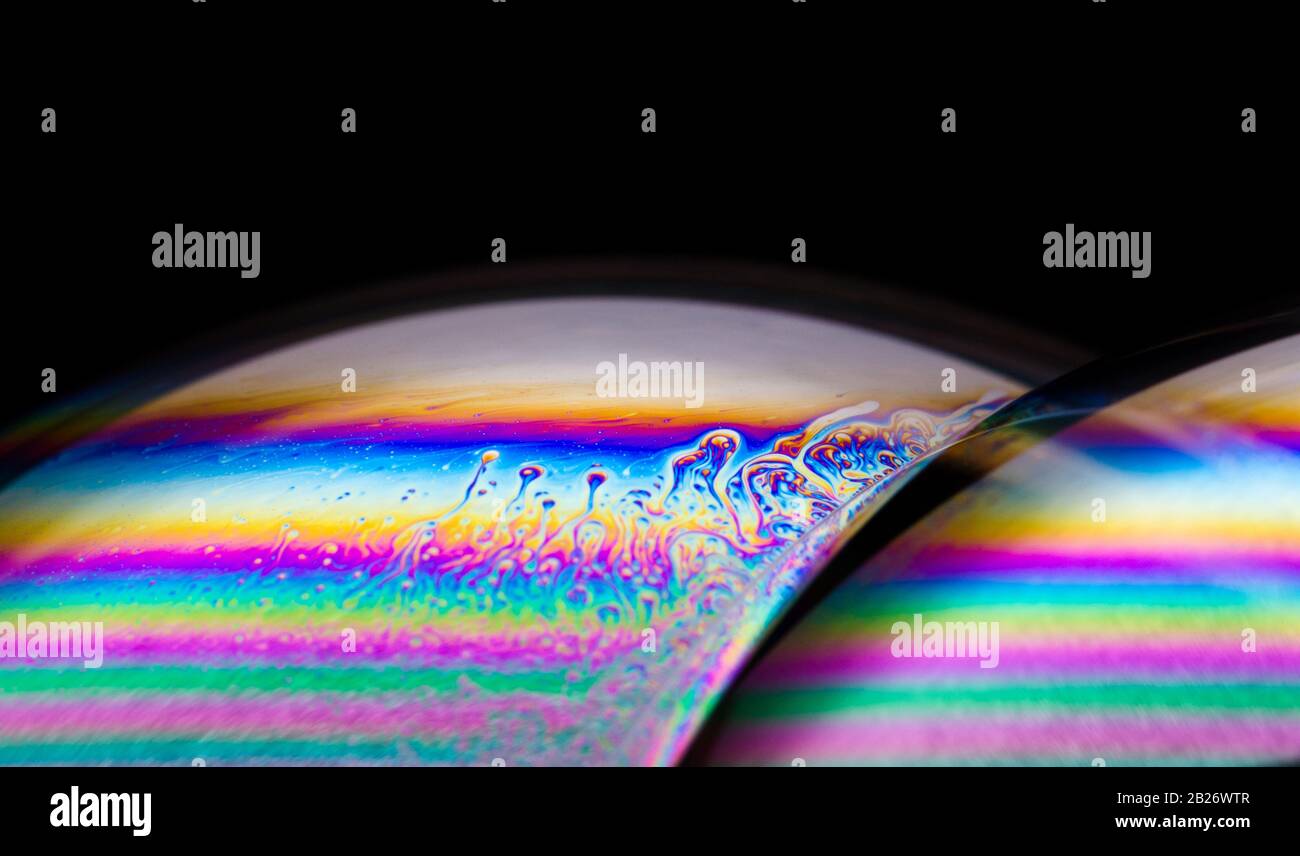 Macro of colorful iridescent soap bubble with abstract patterns and ...