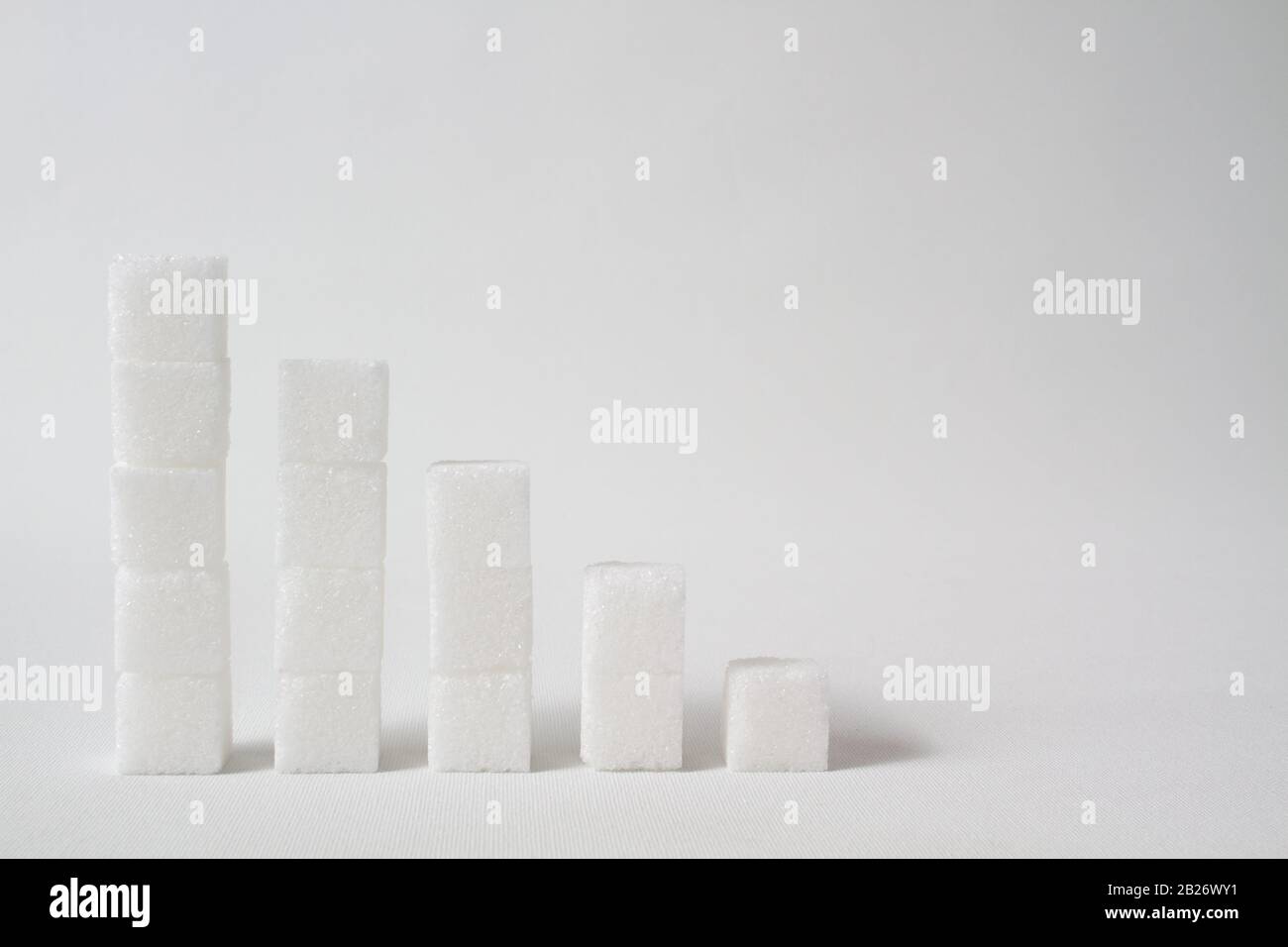 high key of five collumns made of sugar cubes with decreasing height ...