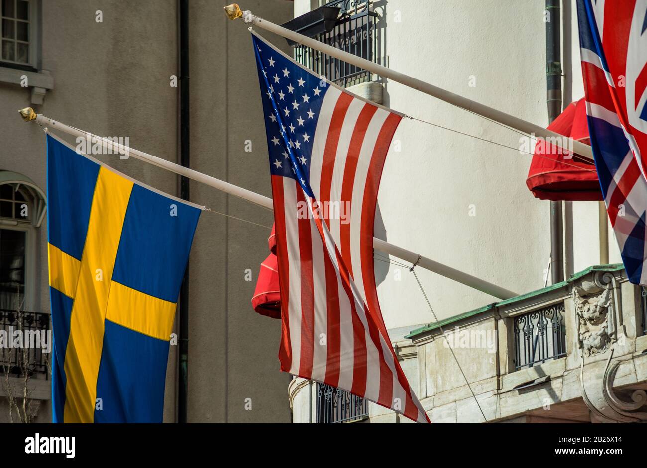Flags of Great Britain, USA and Sweden on the facade of the hotel Stock ...