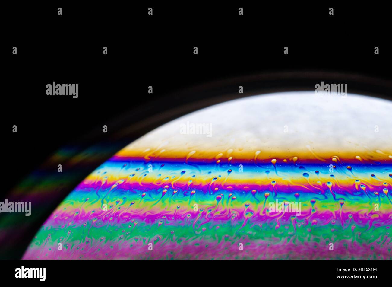 Macro of colorful iridescent soap bubble with abstract patterns and ...