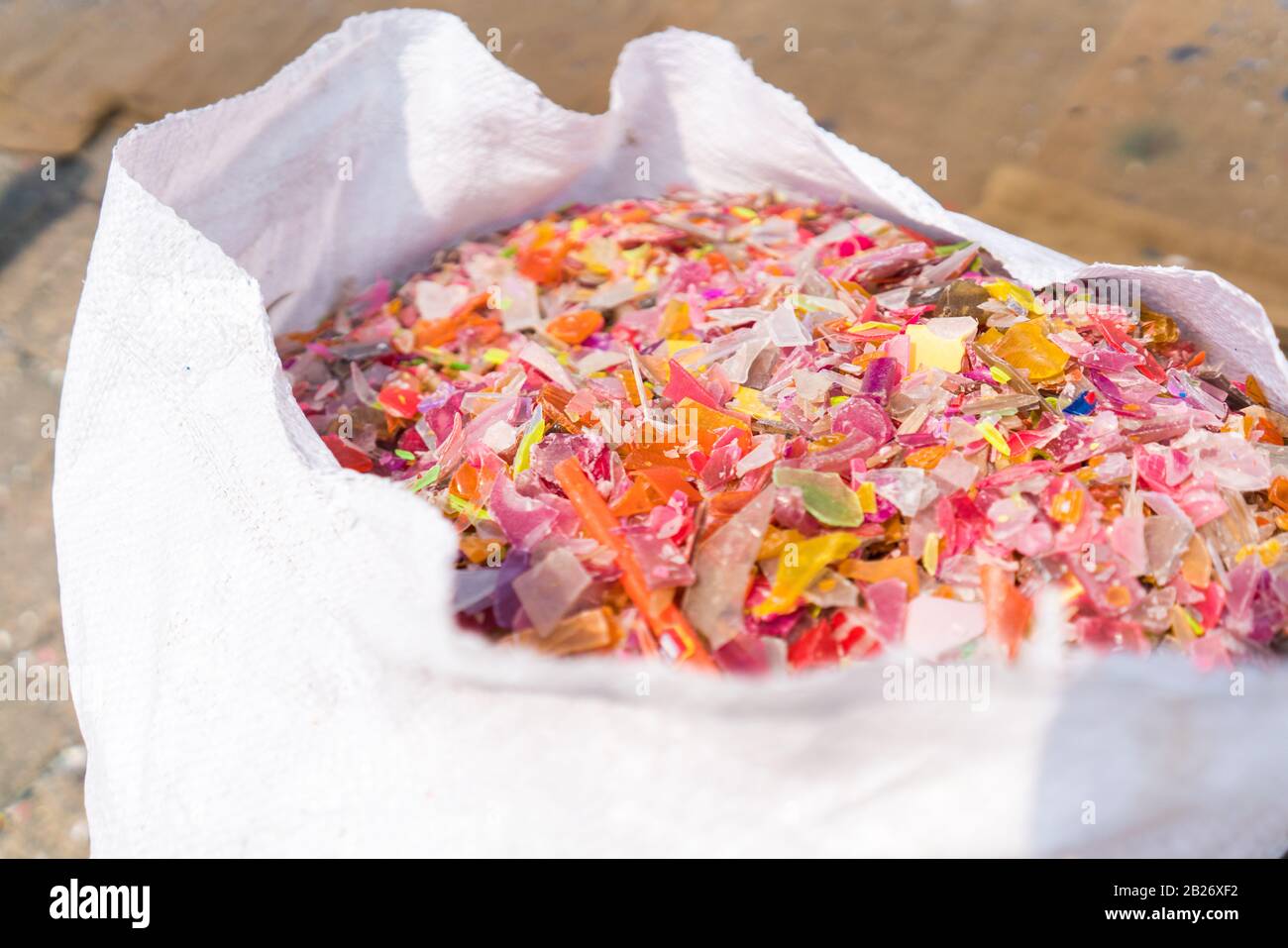 Cleaned pink recycled waste plastic pieces in a bag in Dhaka ...