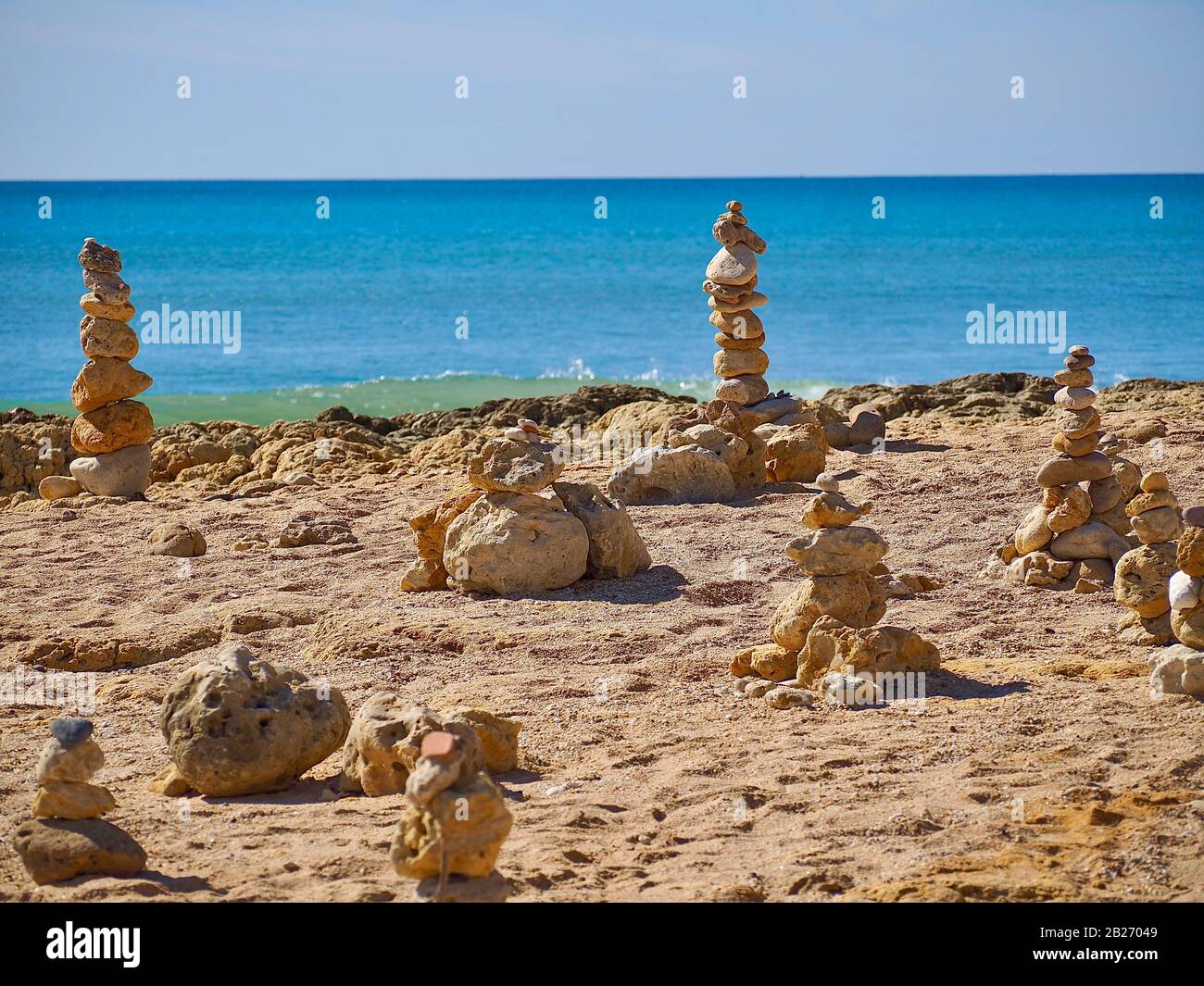 Stack of stones for balance and harmony in front of blue ocean Stock ...