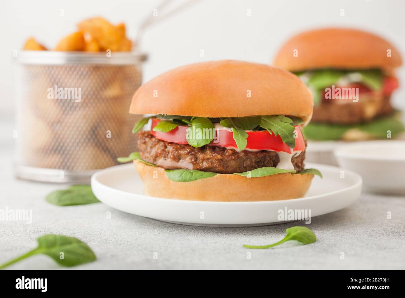 Healthy vegetarian meat free burgers on round ceramic plate with ...