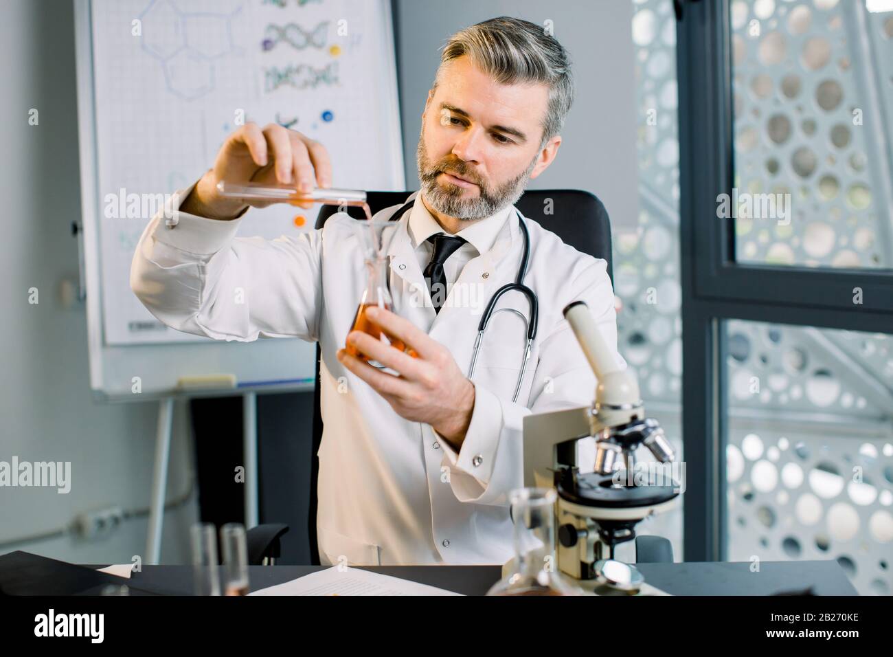 Caucasian man virologist, bio chemist, scientist wearing white coat ...