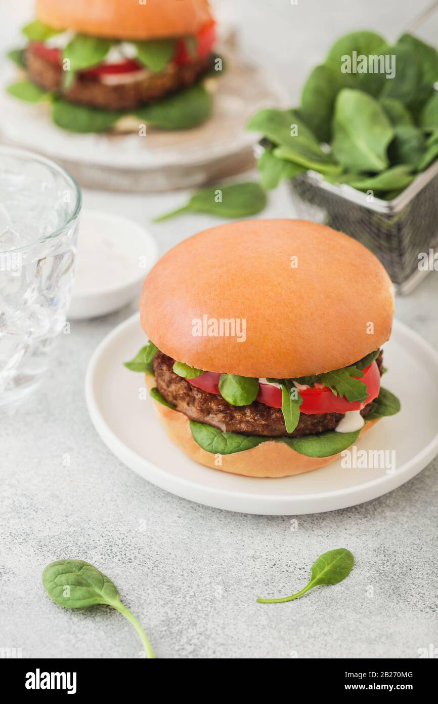 Healthy vegetarian meat free burgers on round ceramic plate with ...