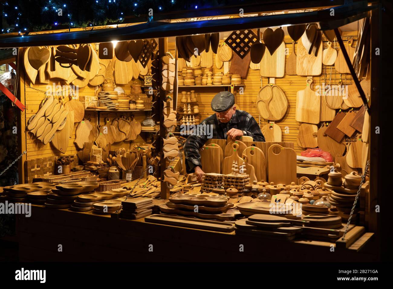Man selling traditional wooden kitchen utensils at Christmas Market ...