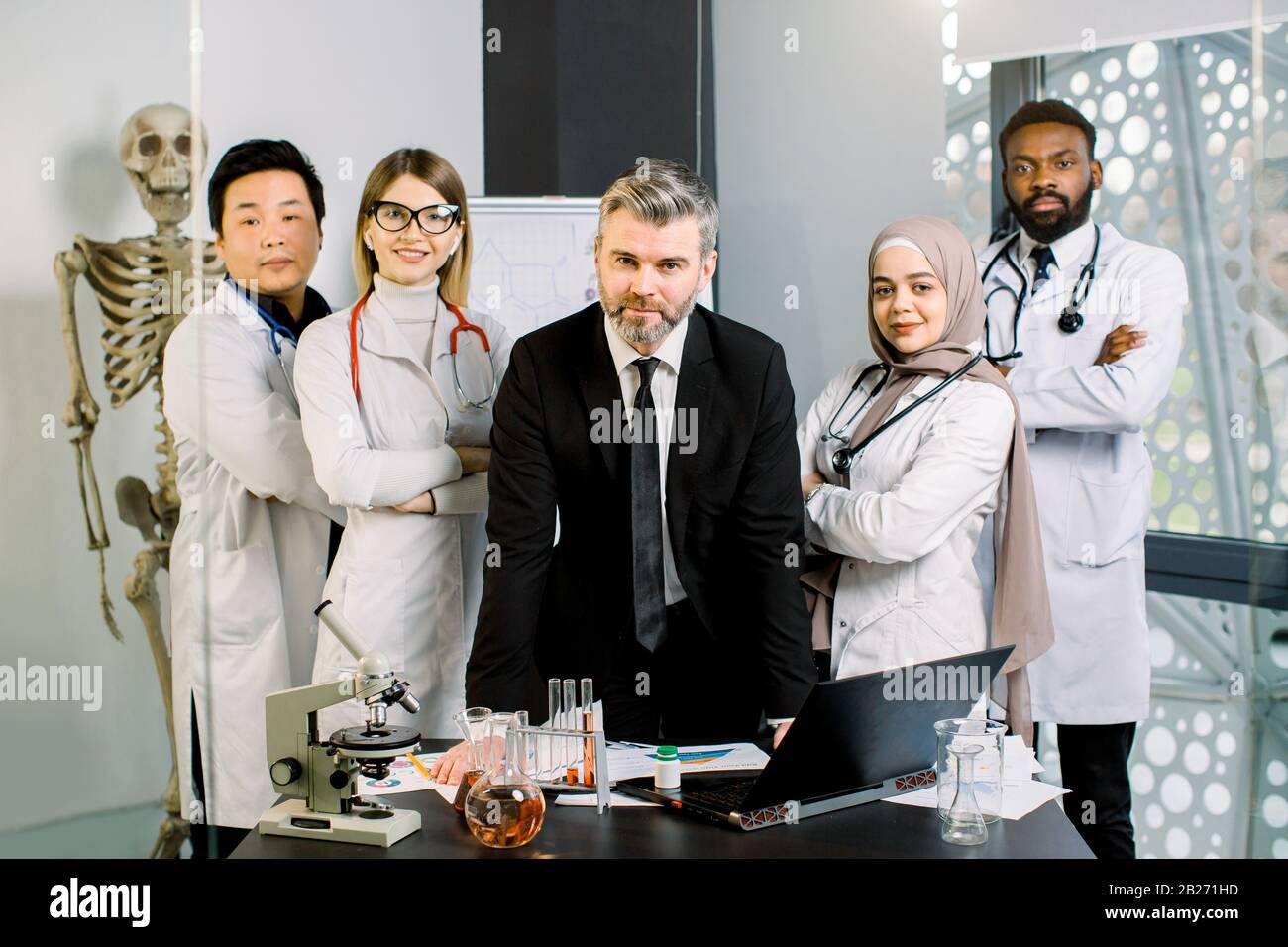 Mature handsome man, medical professor smiling at the camera while ...