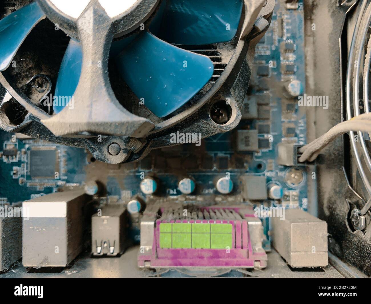 Dust in computer case. Computer circuit board and CPU cooling fans ...