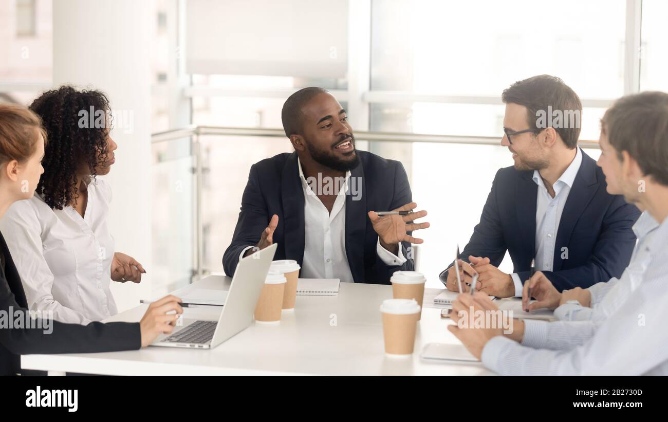 Black male boss leading corporate in team meeting Stock Photo - Alamy