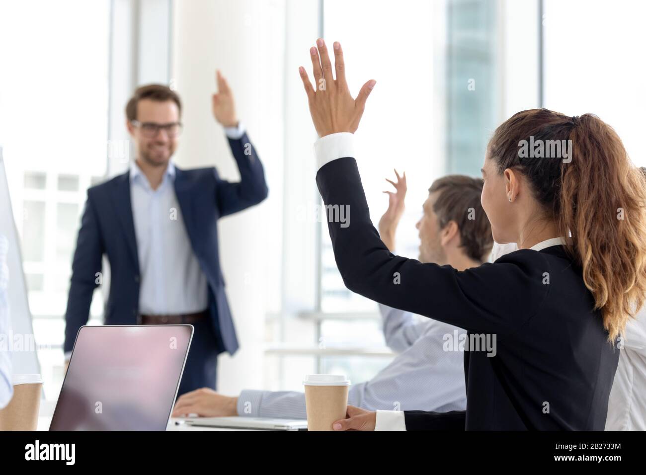 Young beautiful woman raise hand for question boss at presentation ...