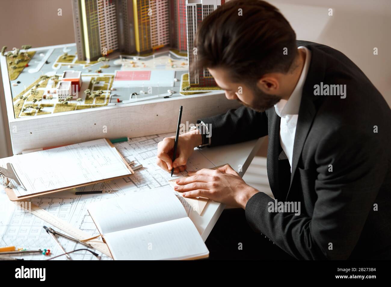 young hardworking achitecter making new building layout, close up side ...