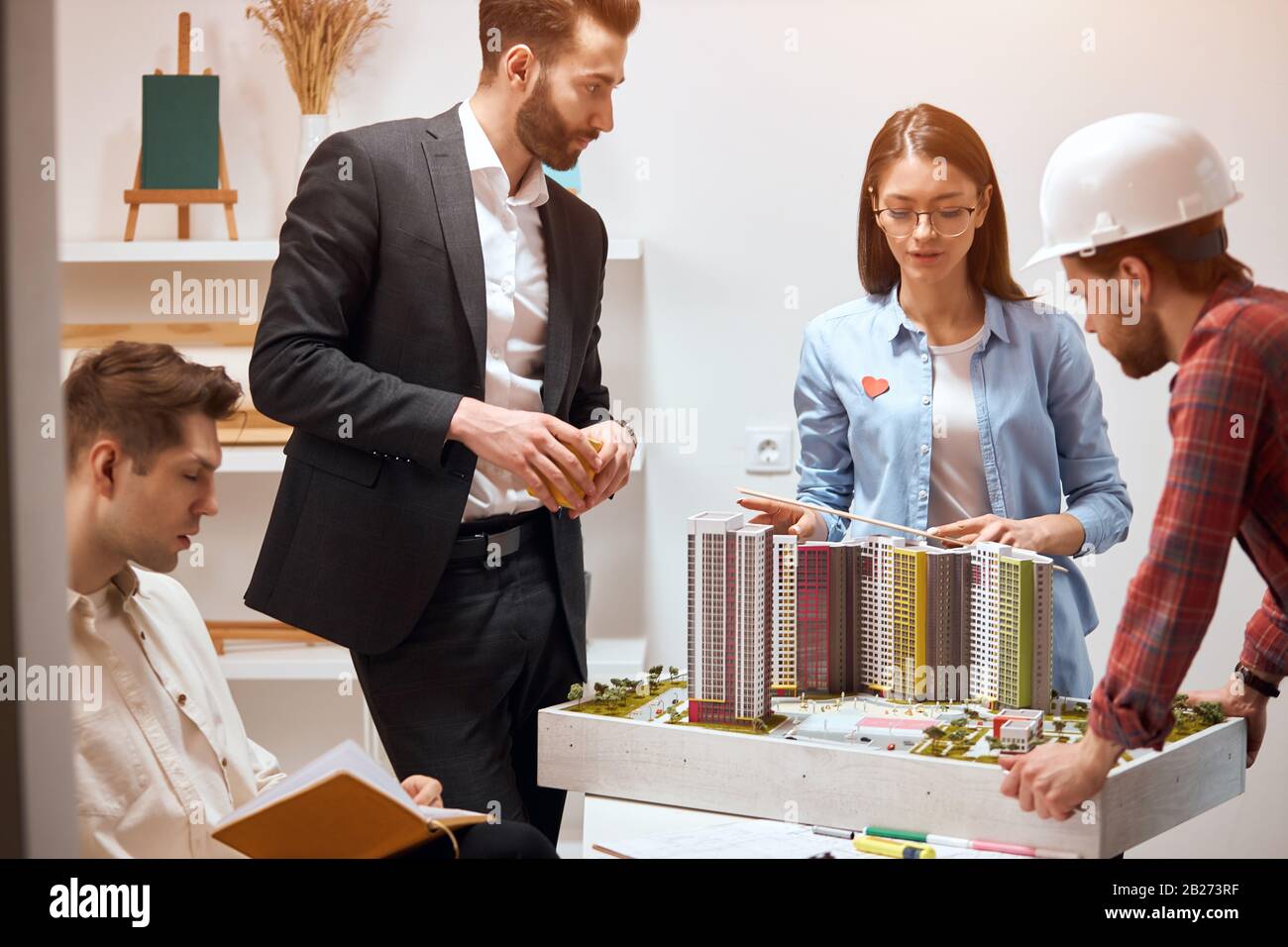 clever leader in glasses manages the process of construction, checking ...